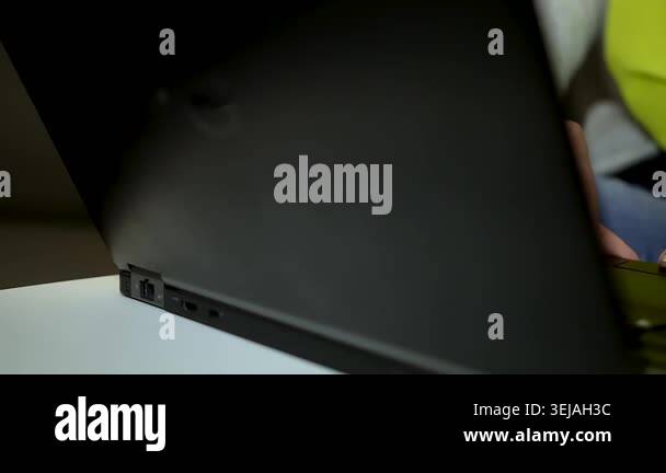 Close-up of a woman's hands using a laptop touchpad. Fingers glide ...