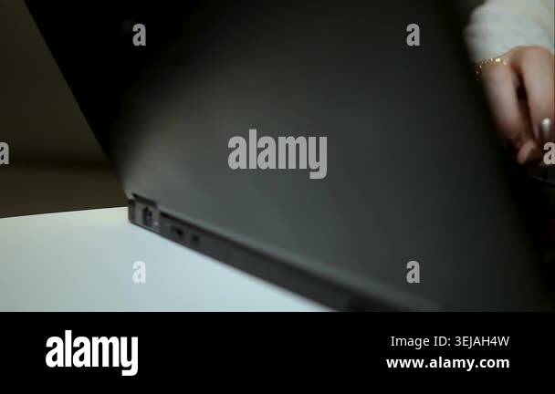 Close-up of a woman's hands using a laptop touchpad. Fingers glide ...