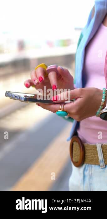 Vertical shot. Close-up of a womans hands. Railway theme. A young woman ...