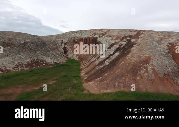 Eroded sandstone mounds with lichen patterns form unique shapes under ...
