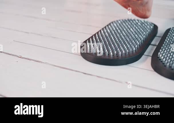 Woman stands on the sadhu board. Close-up of a leg, slider shot ...