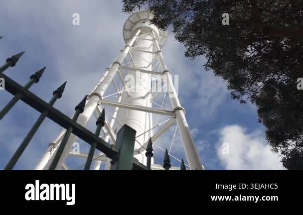 A low-angle shot captures the towering structure of McCrae Lighthouse ...