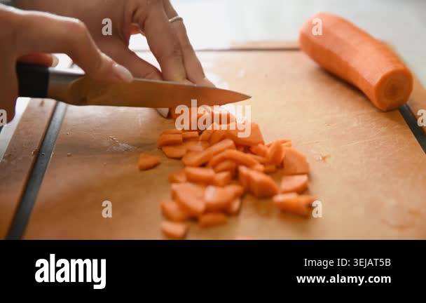 Close up of manual chopping process with sharp kitchen knife preparing ...