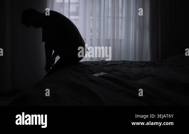 Young man sitting alone in the dark after messaging, feeling ignored ...