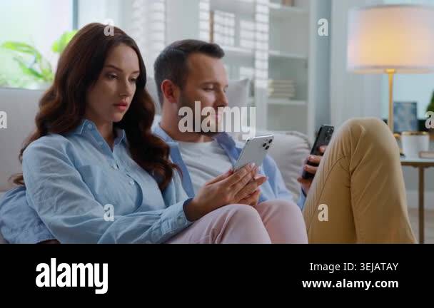 Concentrated gadget addicted Caucasian couple using gadgets mobile ...