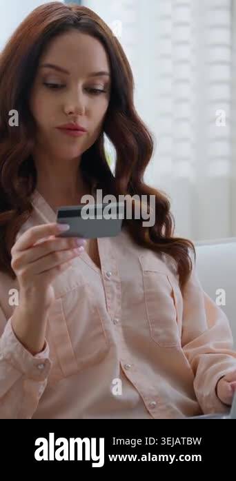 Confused Caucasian girl entering bank credit card number shopping ...