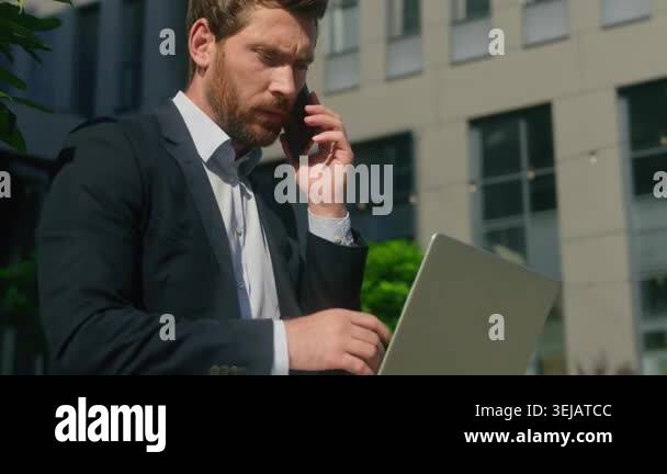Serious focused Caucasian middle aged business man multitasking ...