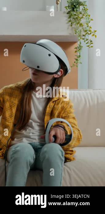 Concentrated little Caucasian child girl in vr glasses exploring ...