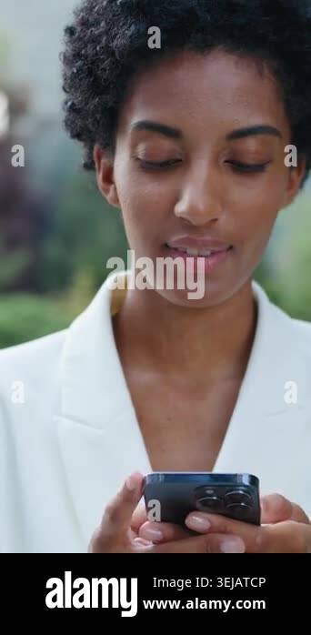Gadget addict African American business woman using mobile phone app ...