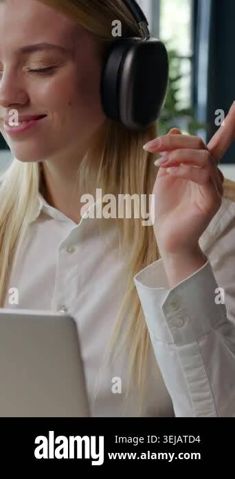 Happy inspired Caucasian business woman typing laptop listening music ...