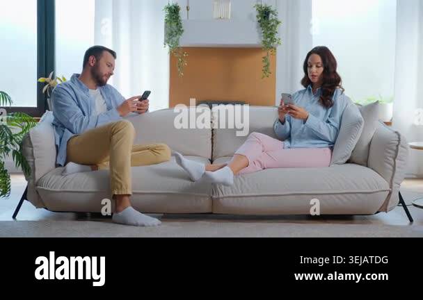 Gadget addicted Caucasian couple using mobile phones apps separated ...