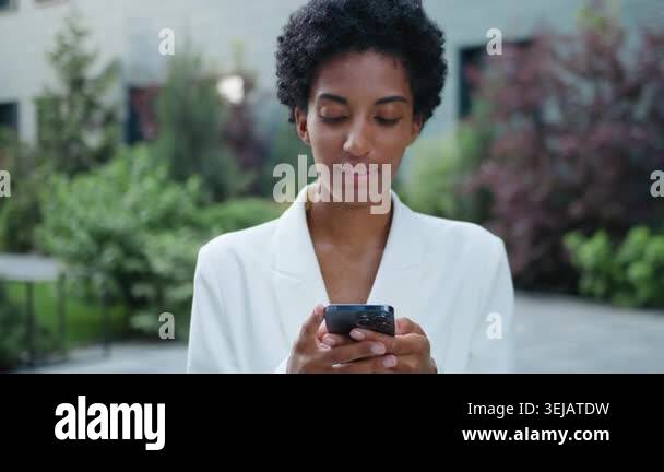 Gadget addict African American business woman using mobile phone app ...