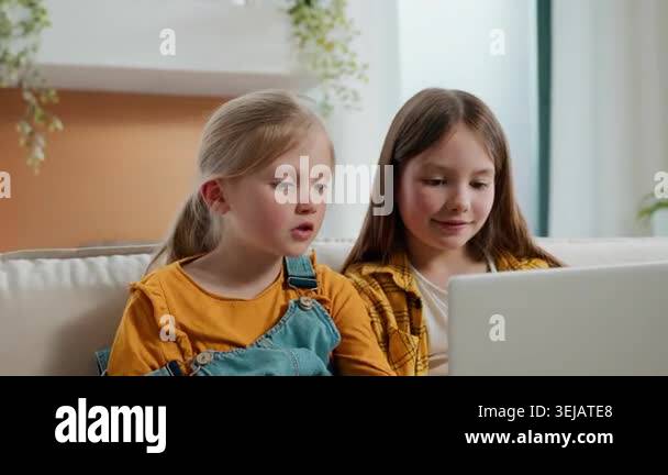 Two little Caucasian girls talking communicate conversation looking in ...