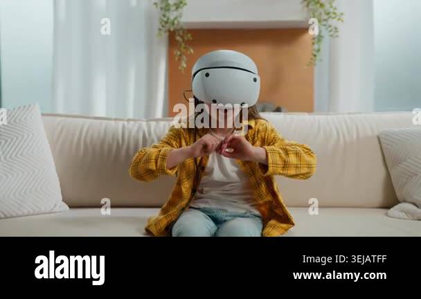 Caucasian little child girl daughter kid playing virtual reality at ...