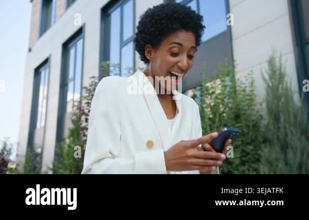 Amazed happy excited African American business woman winning with ...