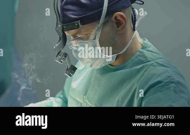 Focused doctor man male surgeon in uniform using electrocautery ...