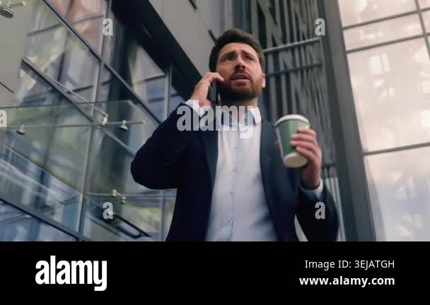 Middle aged Caucasian frustrated business man talking mobile phone ...