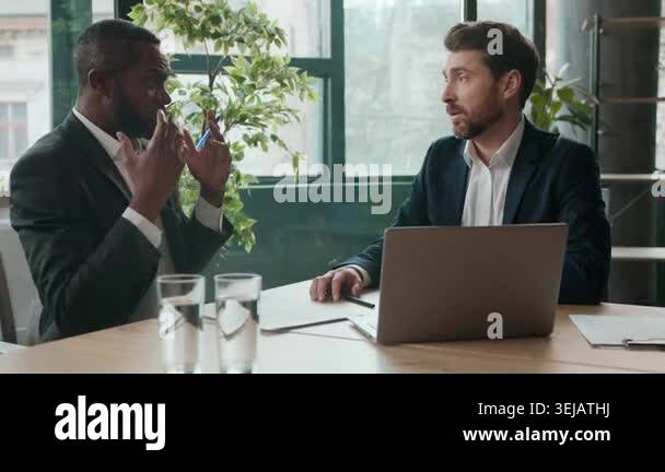 Two diverse business men team multiracial businessmen emotional talking ...
