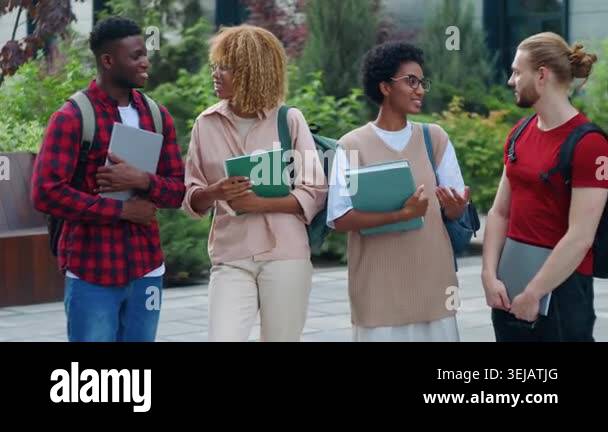 Group of multiethnic students talking smiling greeting hello come here ...
