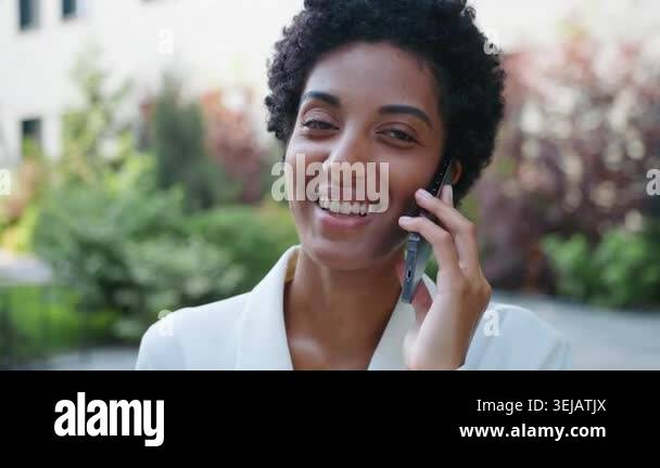 Carefree African American business woman happy talking call with mobile ...
