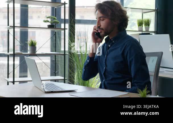 Indian ethnic Arabian businessman checking papers talking call looking ...