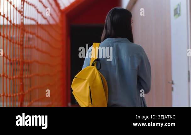 Back view Caucasian student girl walking going with schoolbag in school ...