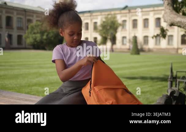 Little girl African American child read book prepare lesson elementary ...