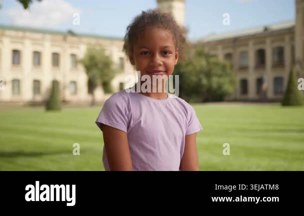 Portrait happy smiling African American little student pupil girl ...