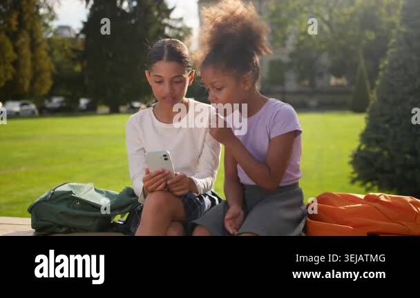 African American little girls children outdoors using smartphone ...