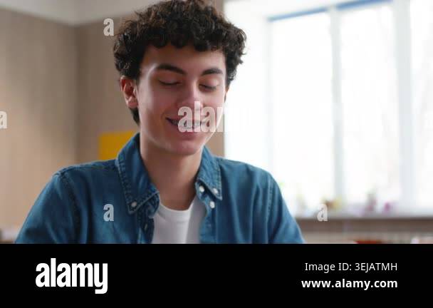 Caucasian happy male student school boy smiling in class lesson typing ...