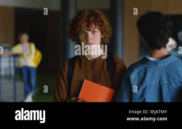 High school Caucasian sad lonely teen boy going frown couple teens push ...