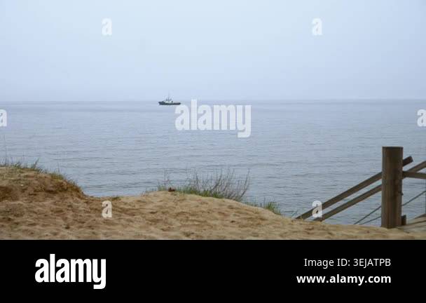 Small boat floats calmly on tranquil sea under soft, diffused lighting ...