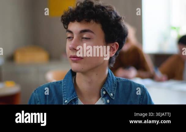 Portrait calm Caucasian pupil teen boy student guy looking at camera in ...