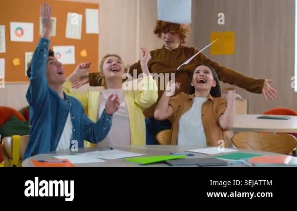Happy students girls guys throw papers pass exam smiling finish ...
