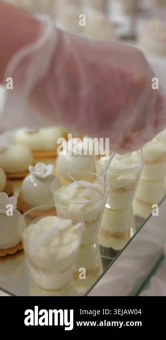 Close-up of professional catering service arranging mini trifles at a ...