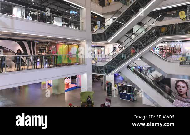 4K Time lapse video of modern shopping mall interior with escalators ...