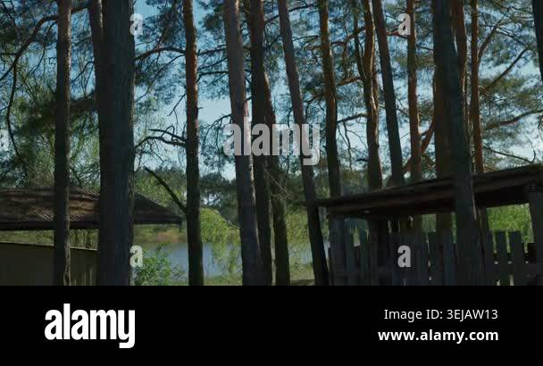 Scenic view of a tourist base with timber huts under a blue sky, audio ...