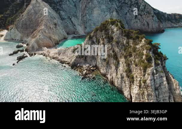 Rocky headland by clear blue sea and steep cliffs in Cephalonia Island ...