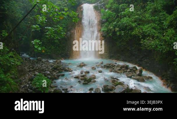 Main Blue Falls cascade dropping into turquoise water surrounded by ...