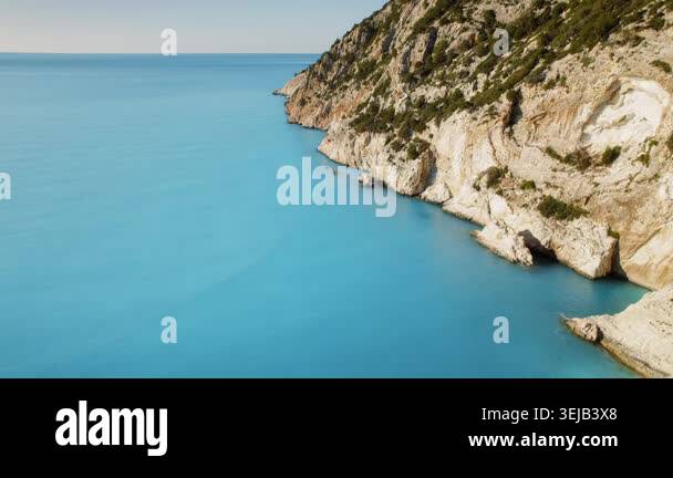Jagged limestone cliffs meet the calm expanse of turquoise Ionian sea ...