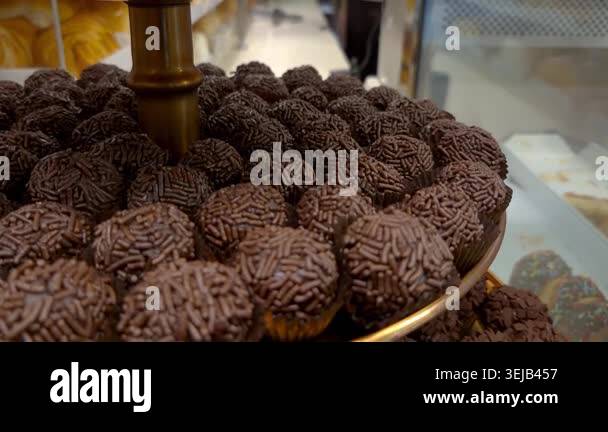 Closeup of chocolate fudge balls with sprinkles in a bakery window mini ...