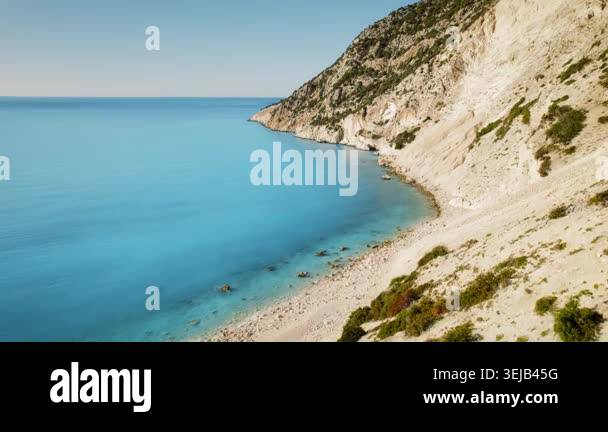 Pristine coastline with turquoise sea waters bordered by steep rocky ...
