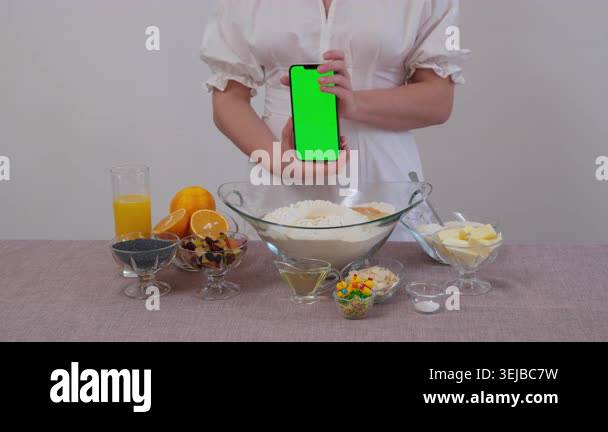 green screen while preparing sweet pastry near flour, oranges, raisins ...