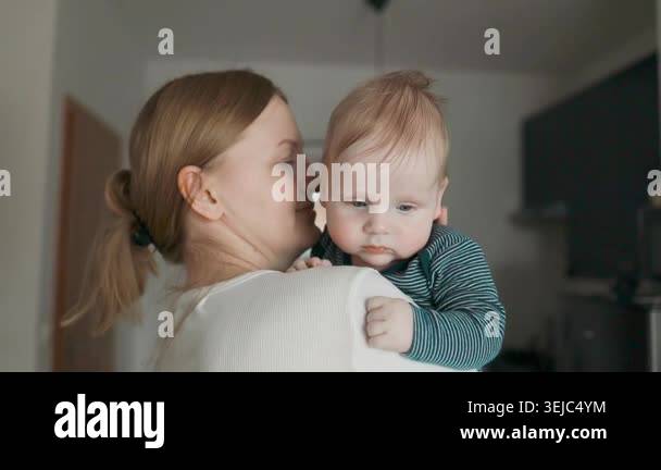Portrait of a happy mother carrying her small son, family bonding ...
