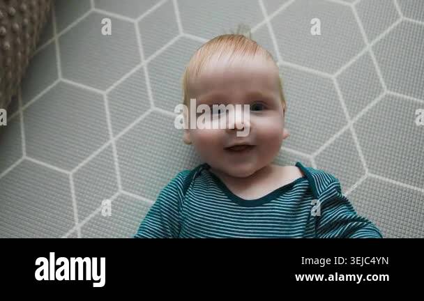 Portrait of a joyful infant child laughing and bonding at home, close ...