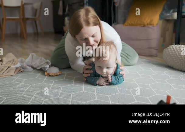 Mother and baby child bonding during playtime in a bright nursery room ...
