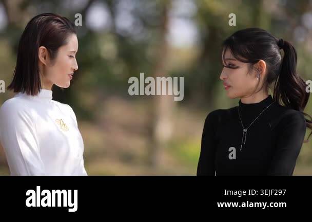 Two women smiling and talking outdoors together Stock Video Footage - Alamy