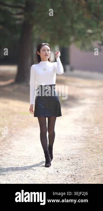 Woman walking outdoors wearing stylish outfit Stock Video Footage - Alamy