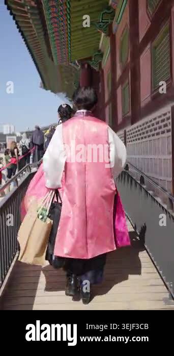 Woman wearing traditional clothing carrying shopping bags Stock Video ...