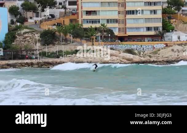 Surfer riding a wave at Poniente Beach in Benidorm, Spain, 24.04.2026 ...